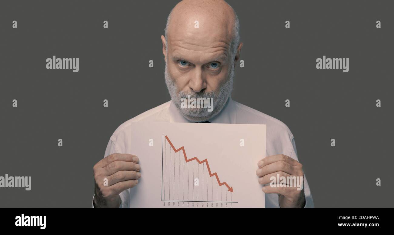 Worried businessman holding negative financial hi-res stock photography ...