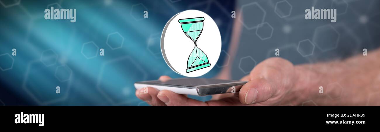 Time management concept above a smartphone held by a man Stock Photo ...