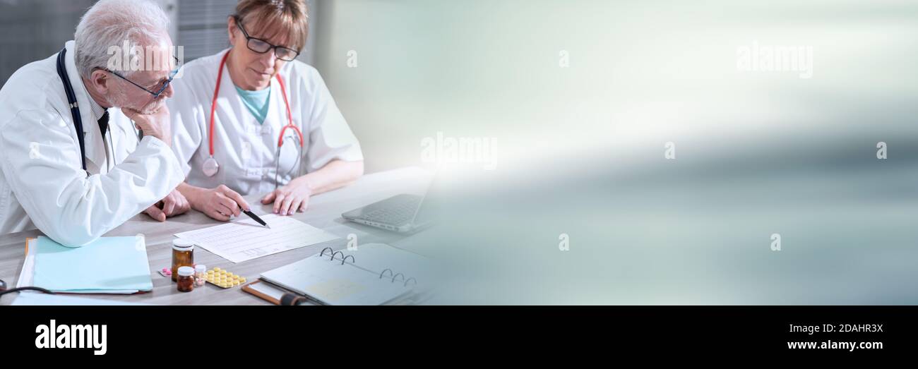Two doctors discussing about medical results in clinic; panoramic ...