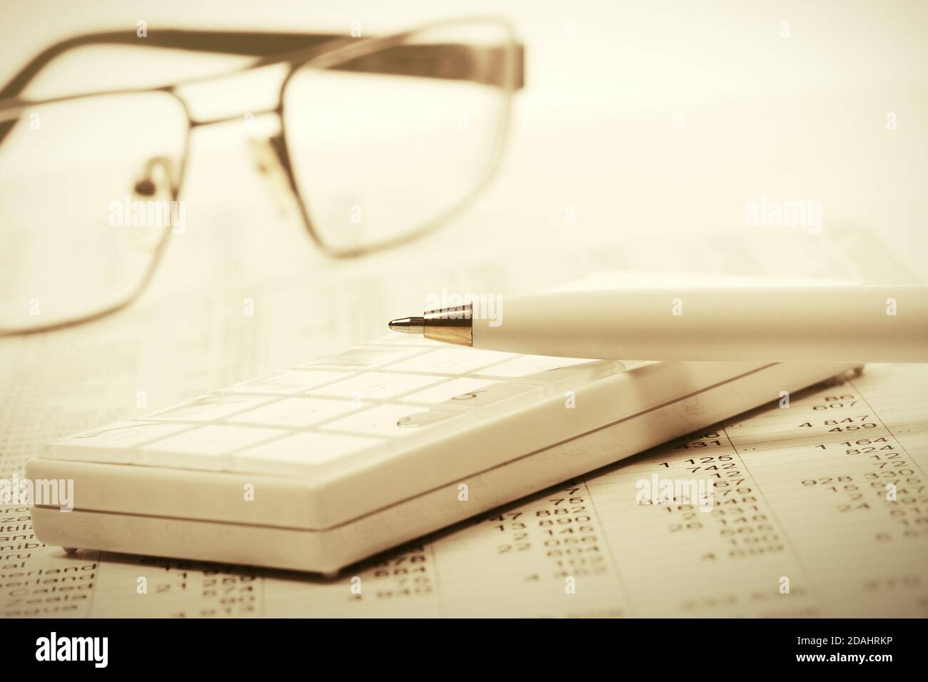 Financial accounting Pen and calculator on balance sheets Stock Photo ...