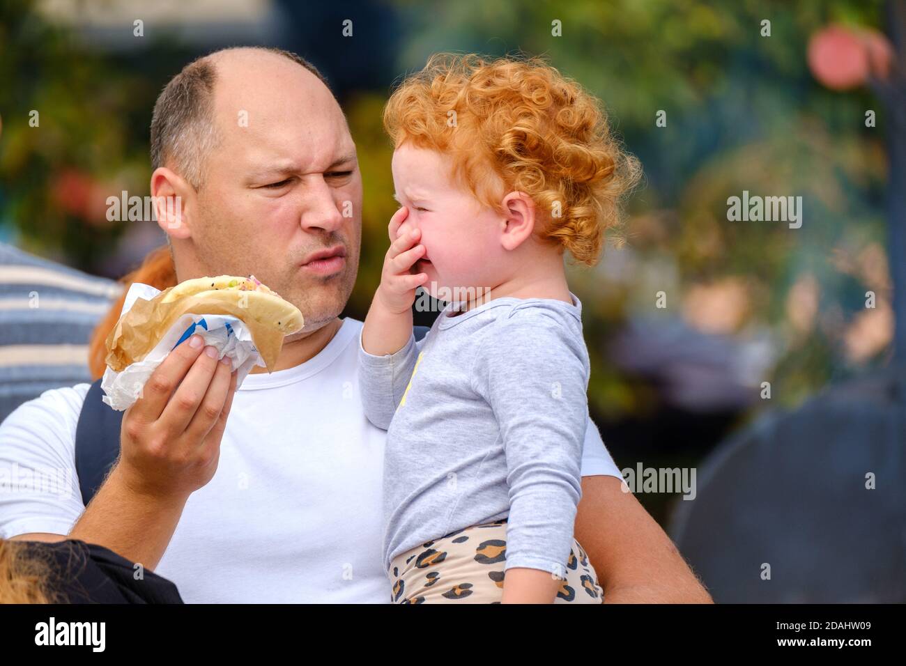 Father giving sandwich to baby Stock Photo - Alamy