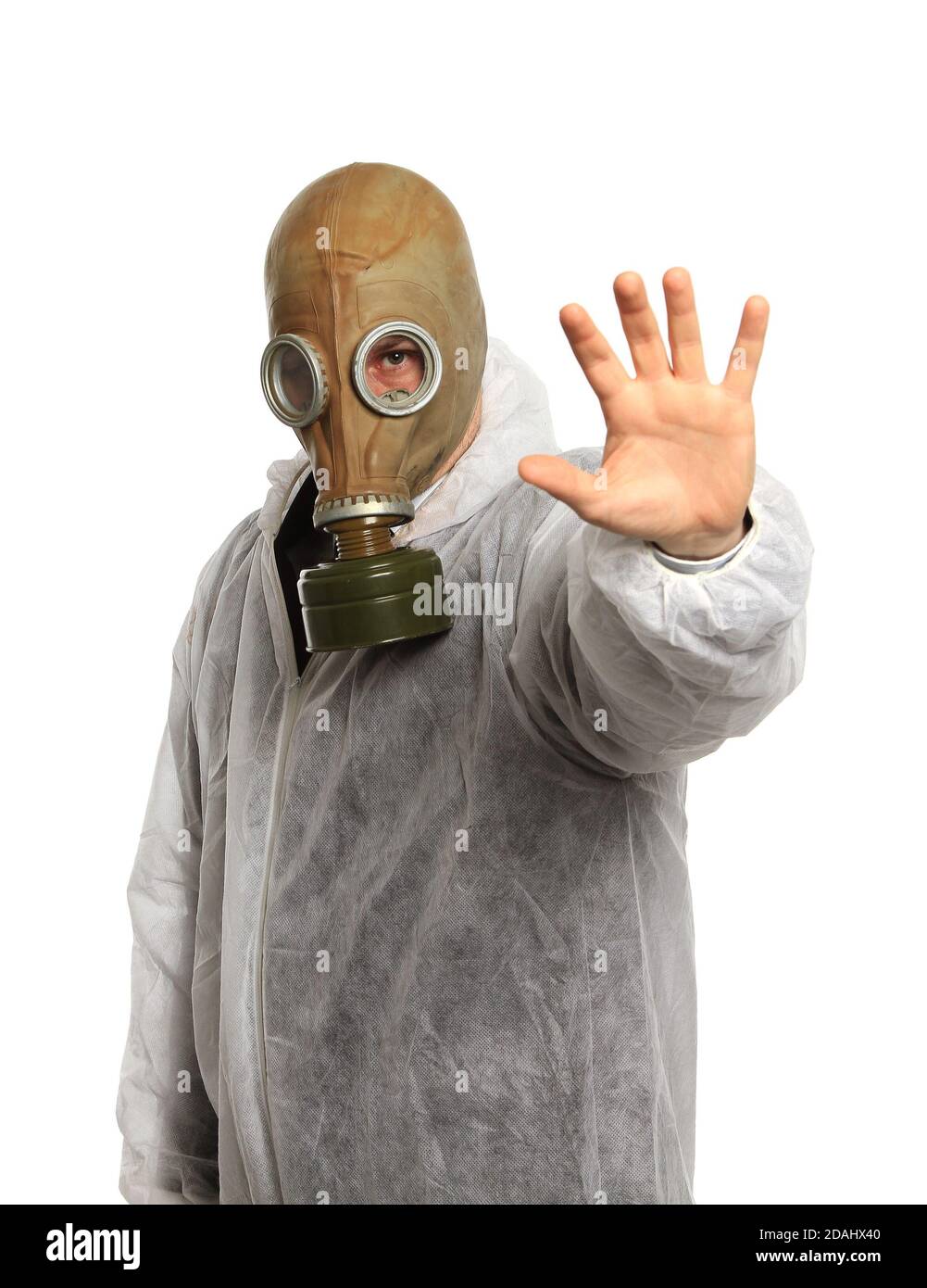 Male in full protective clothing wearing a gas mask and raising his ...