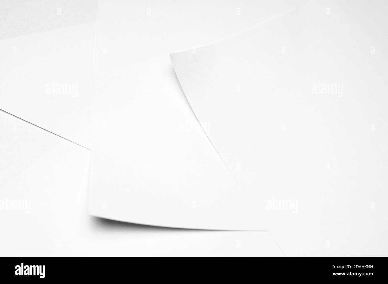 Few blank pieces of white paper Stock Photo - Alamy