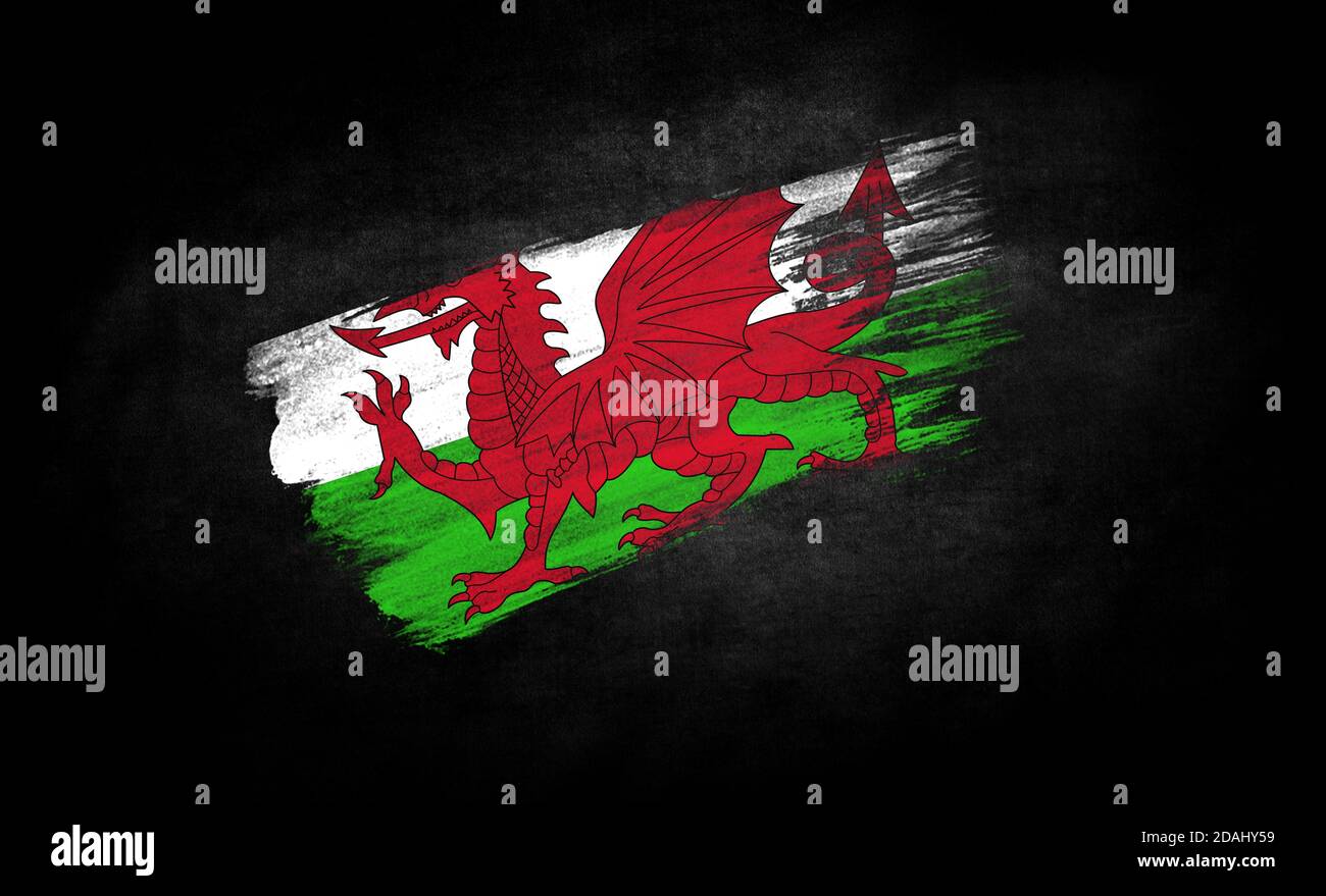 smear of paint in the form of the flag of Wales close-up on a black ...
