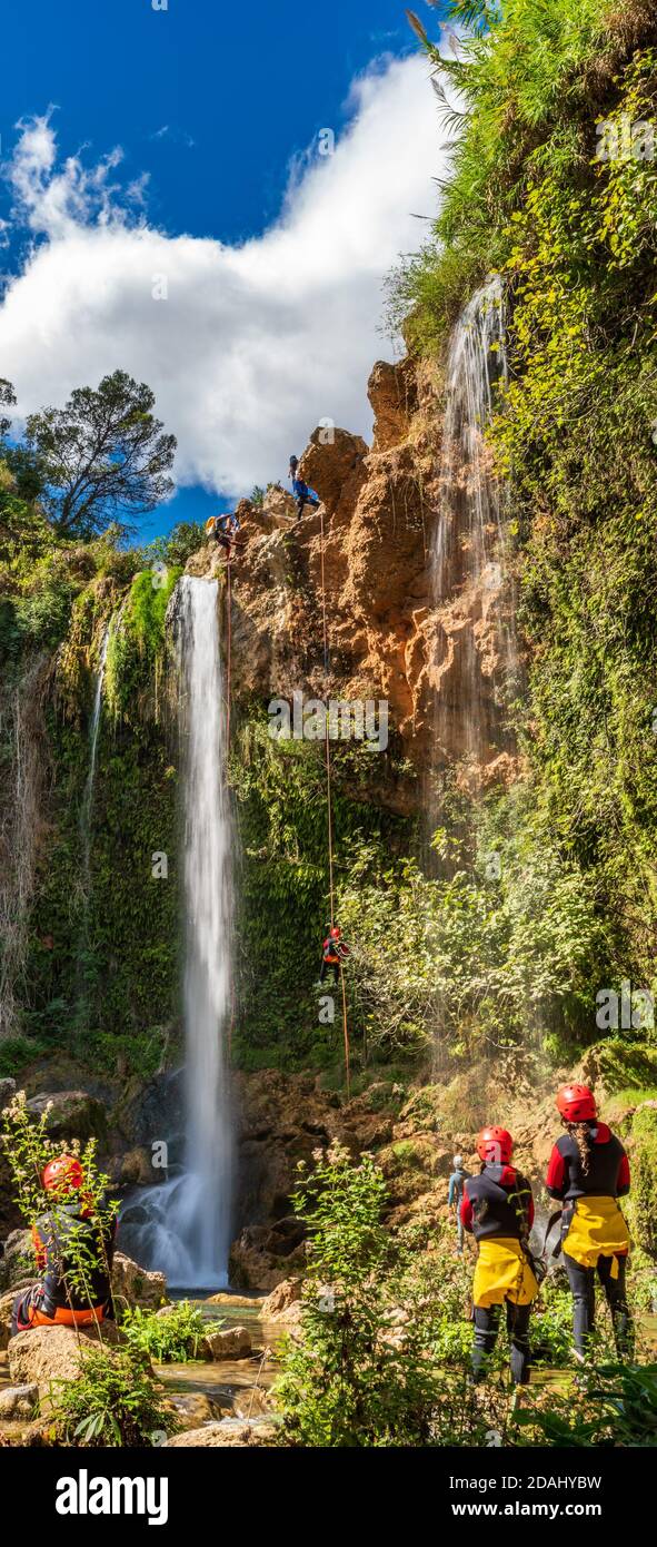 Unrecognizable people descending waterfall using ropes Stock Photo - Alamy