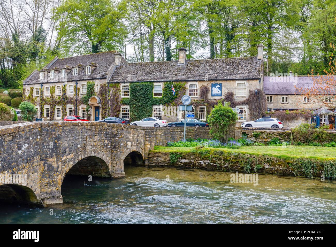 The Swan Hotel and Cotswold stone bridge over the River Coln in Bibury ...