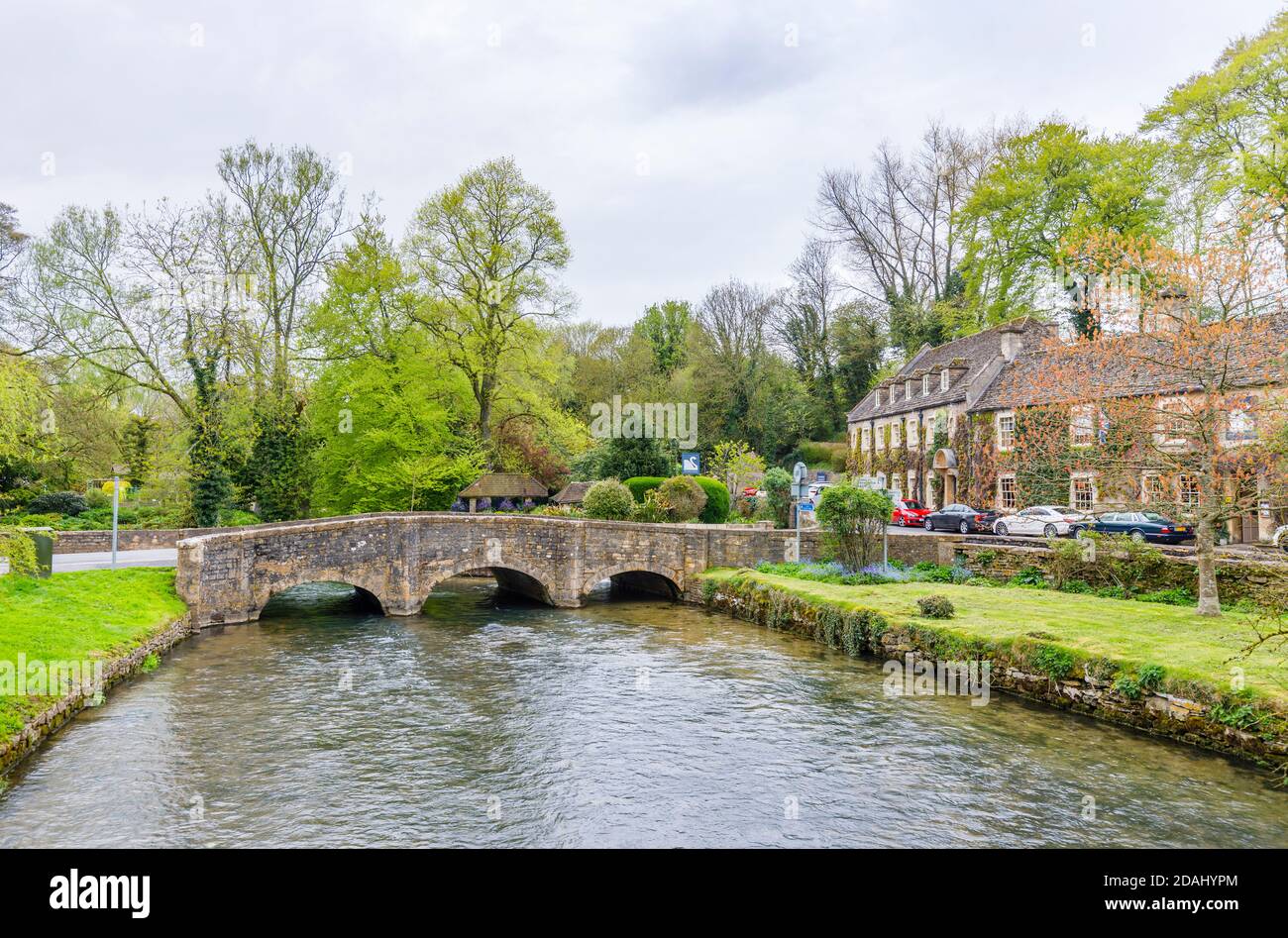 The Swan Hotel and Cotswold stone bridge over the River Coln in Bibury ...