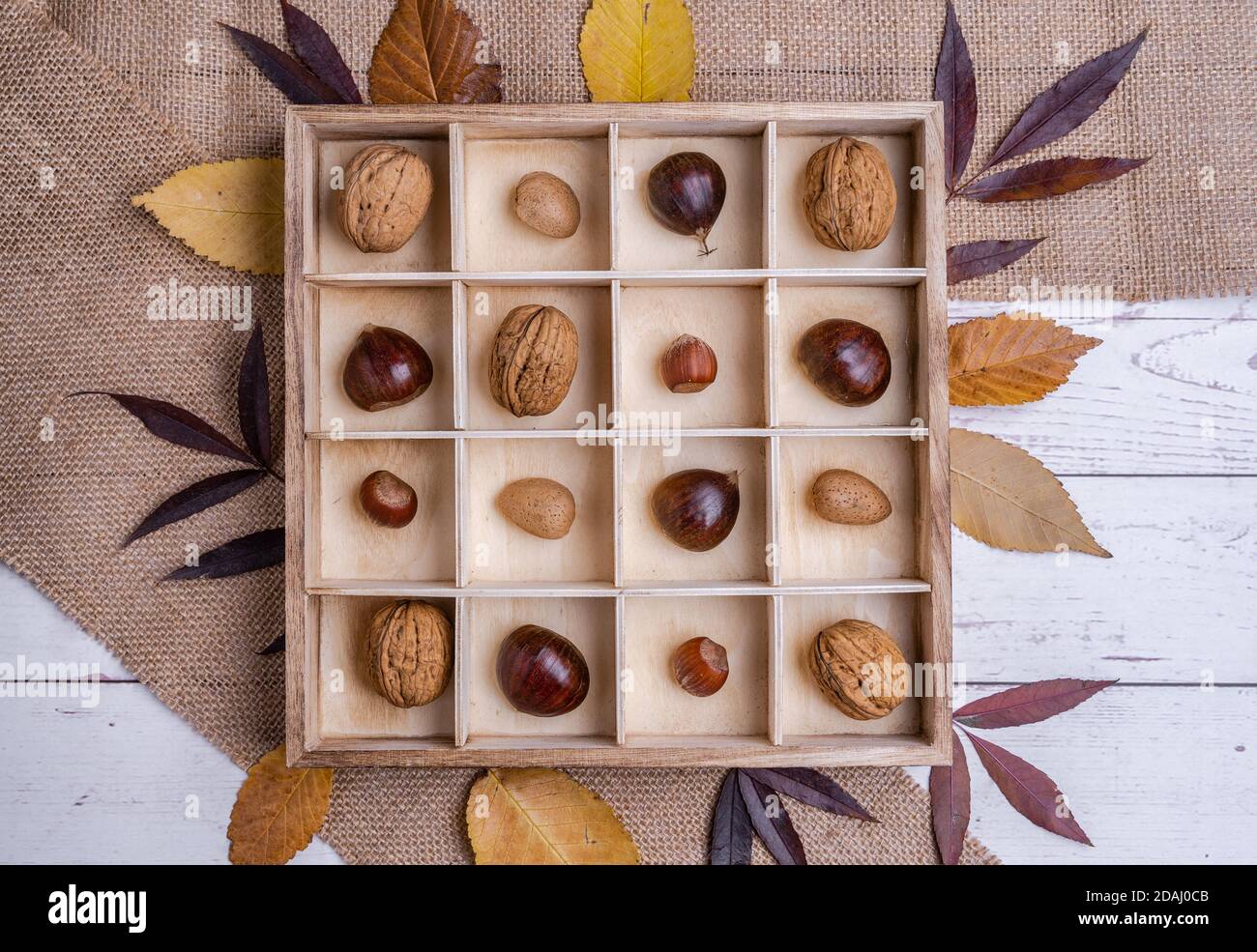Top view of different kinds of nuts in a wooden box Stock Photo - Alamy