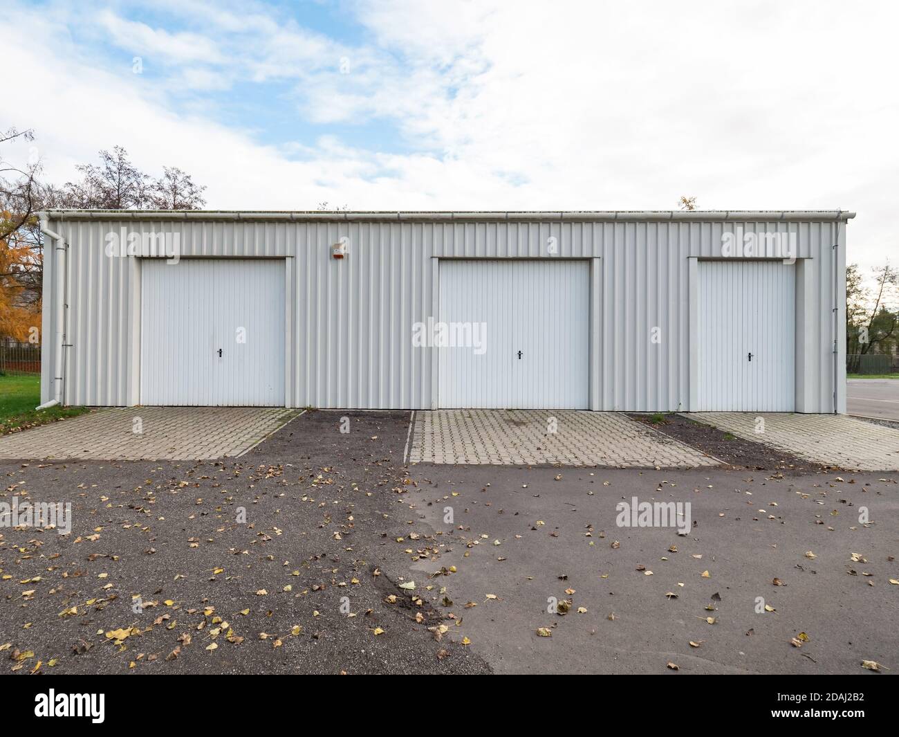 Garage building made of concrete with roller shutter doors. Modern ...