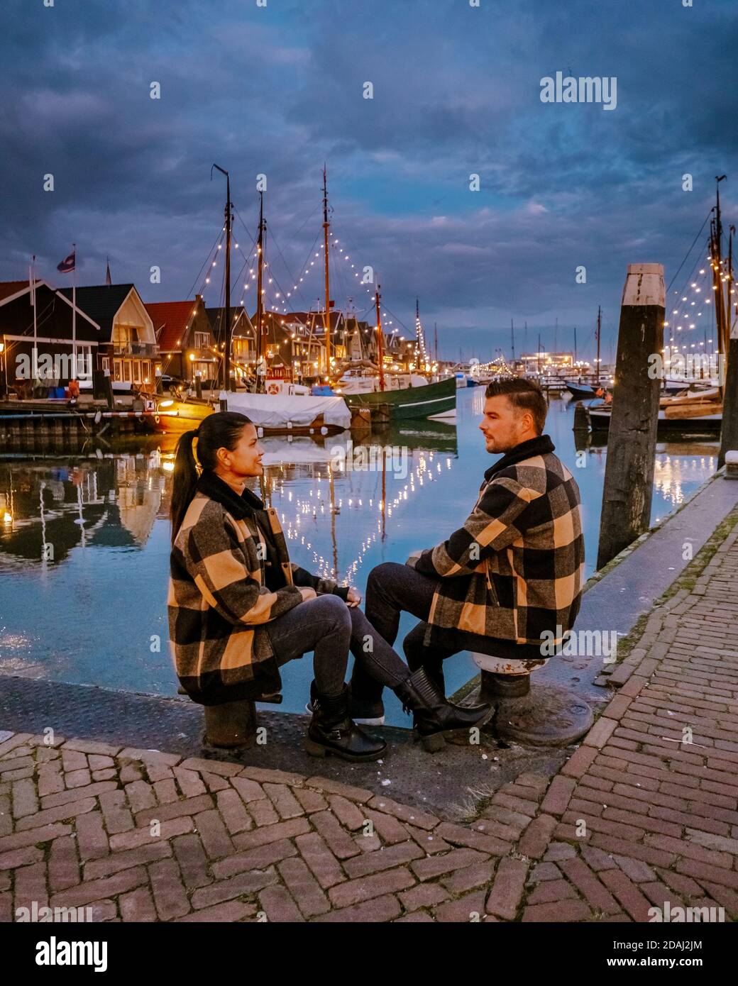 Urk Flevoland Holland,couple men and woman watching sunset at the small ...