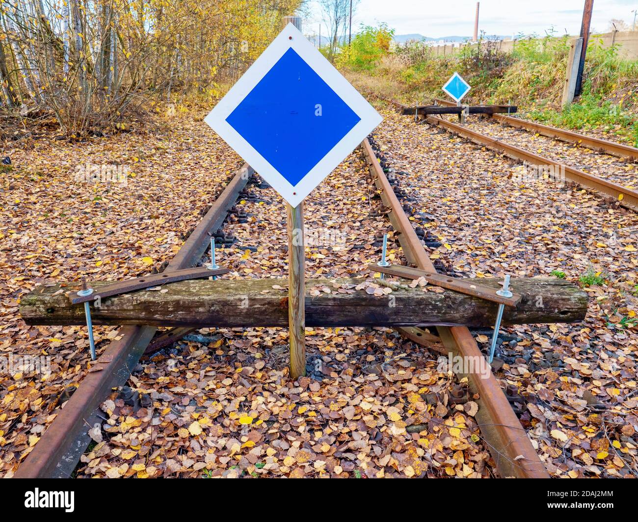 Closed abandoned railway in industry zone. End of track with a train ...