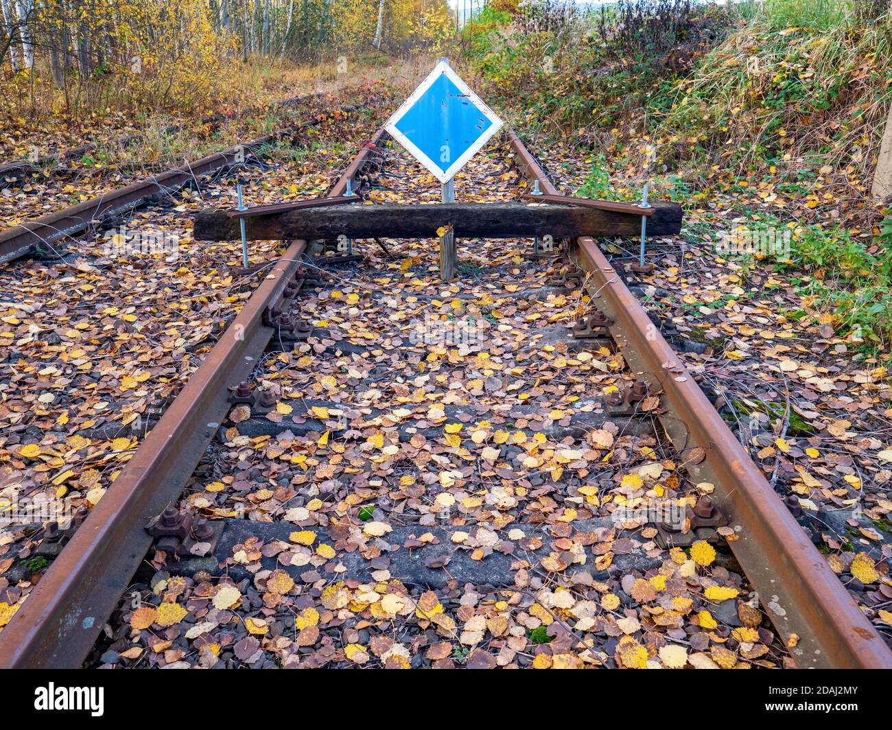 Closed abandoned railway in industry zone. End of track with a train ...