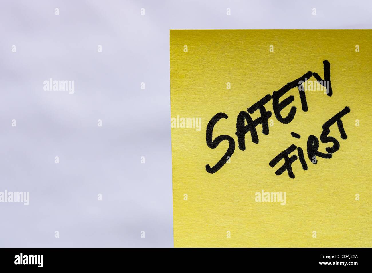 Safety first handwriting text close up isolated on yellow paper with ...