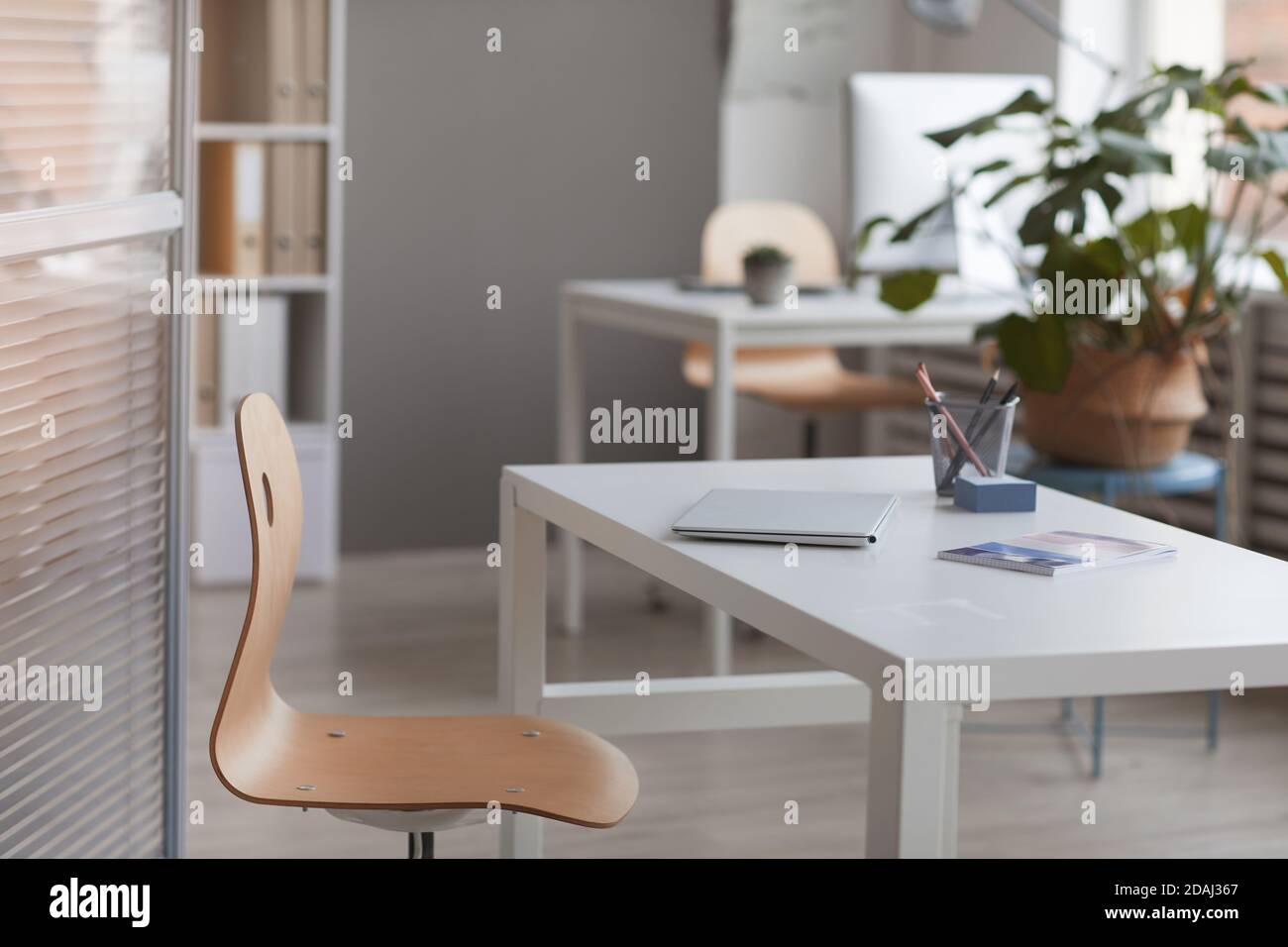 Image of empty desk with laptop at modern empty office Stock Photo - Alamy