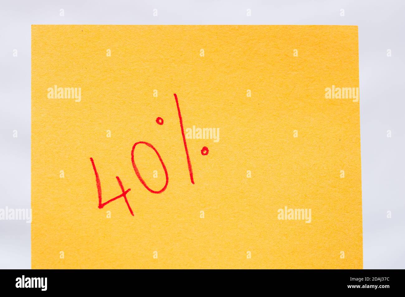 40% handwriting text close up isolated on orange paper with copy space ...