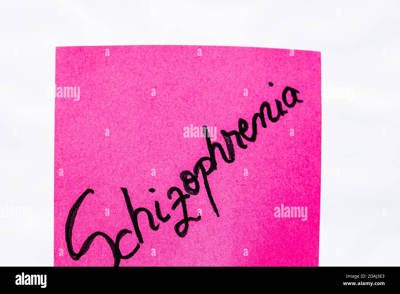 Schizophrenia handwriting text close up isolated on pink paper with ...