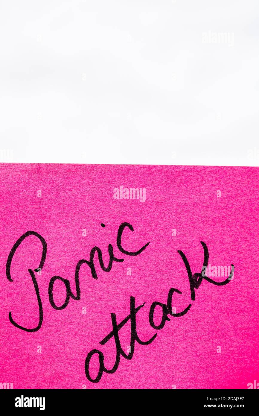 Panic attack handwriting text close up isolated on pink paper with copy ...