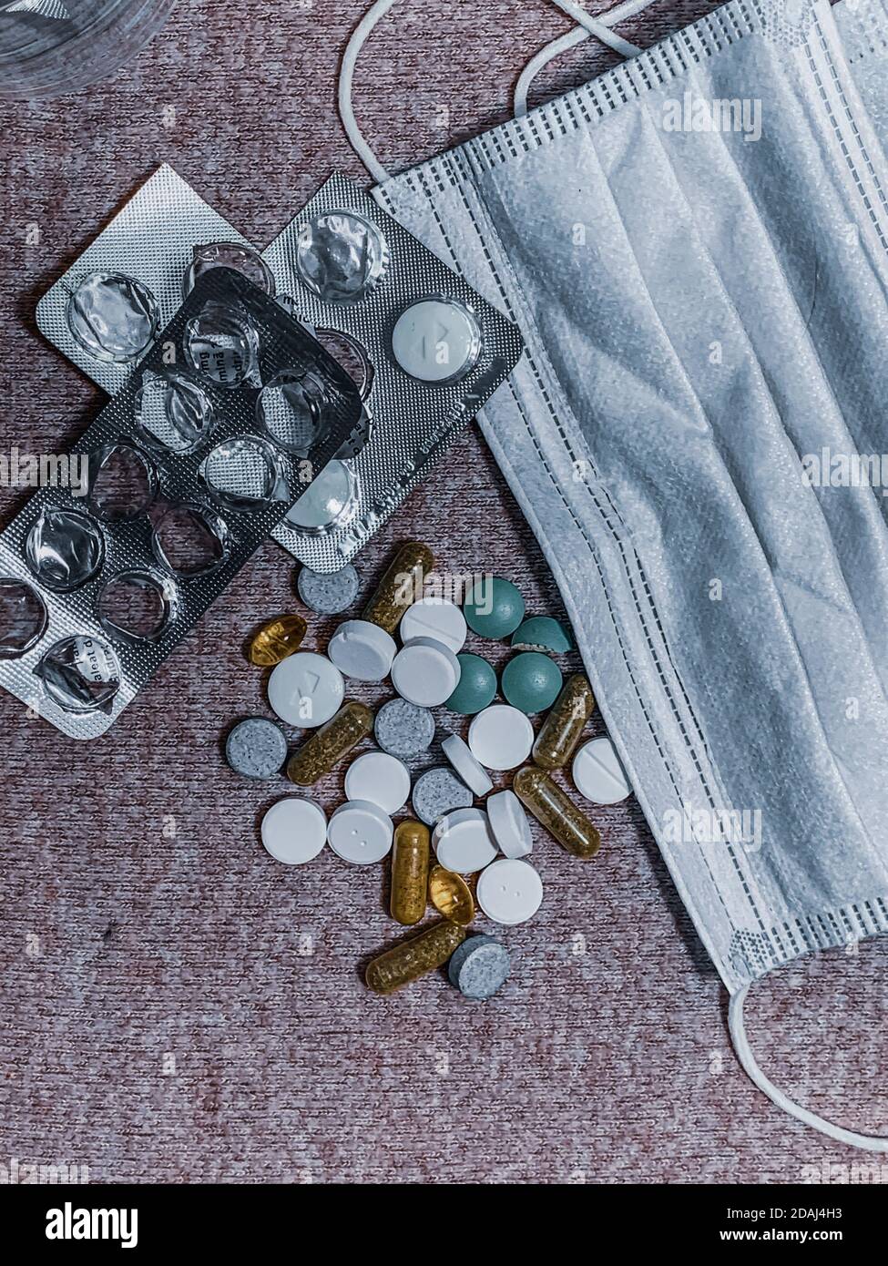 Closeup shot of medicine tablets and a protective mask- COVID-19 Stock ...