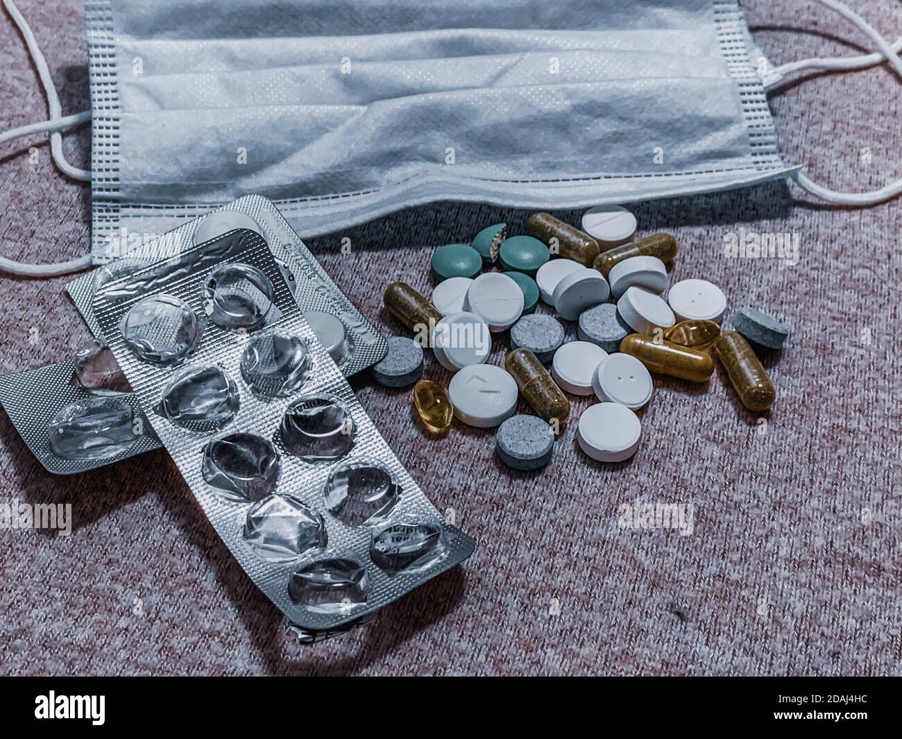 Closeup shot of medicine tablets and a protective mask- COVID-19 Stock ...