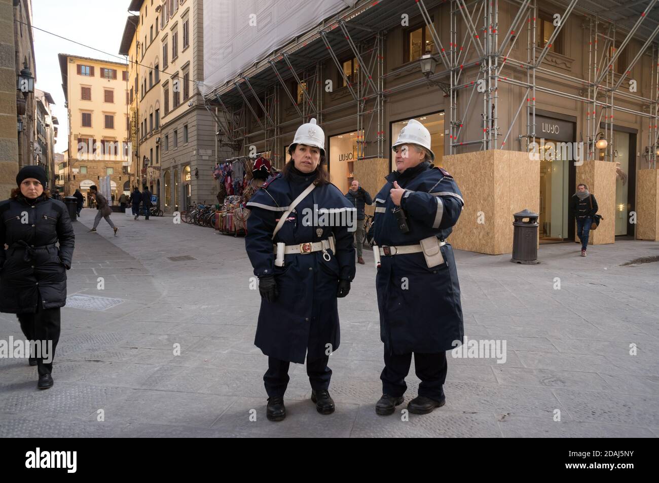 Two female police officers in a special uniform keep order on the city ...