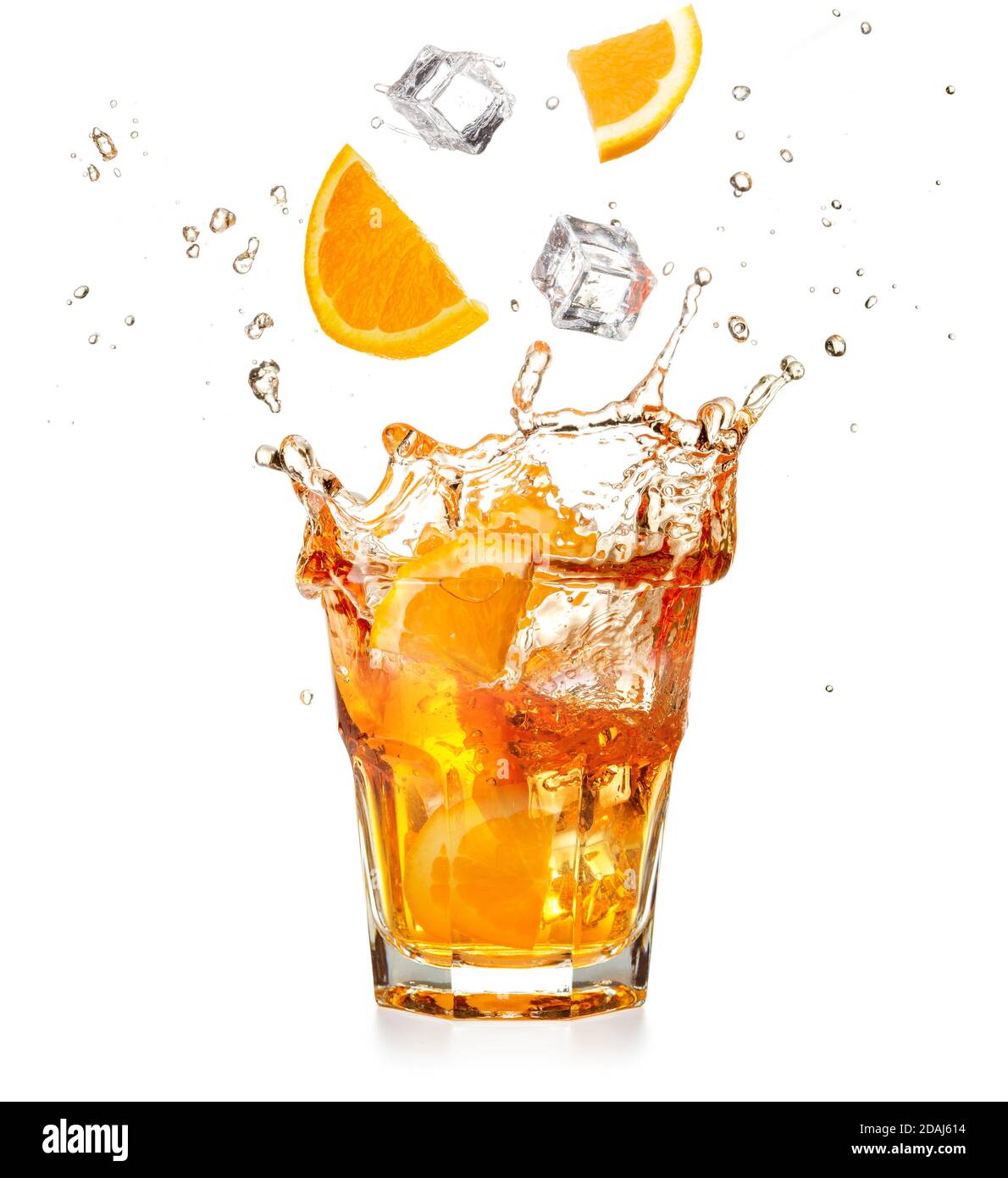 orange slices and ice cubes dropping into a splashing cocktail isolated ...