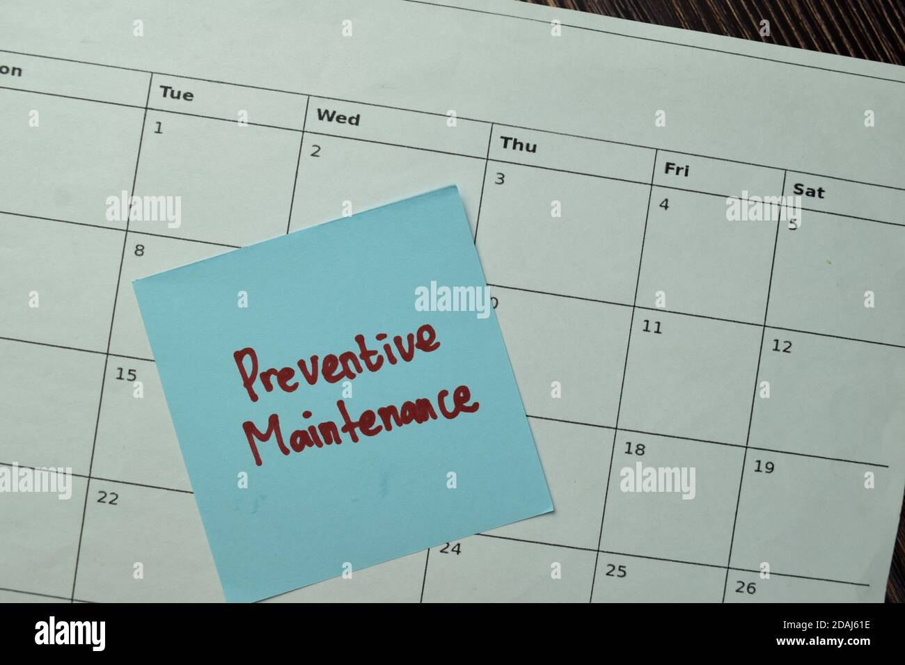 Preventive Maintenance write on sticky note and Calendar date isolated ...
