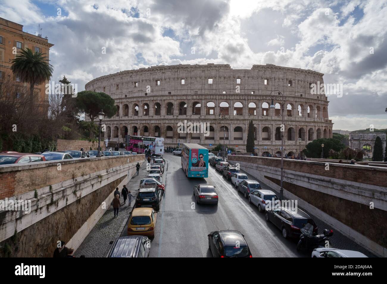 City vehicles go on the road towards the amphitheatre of the Colosseum ...