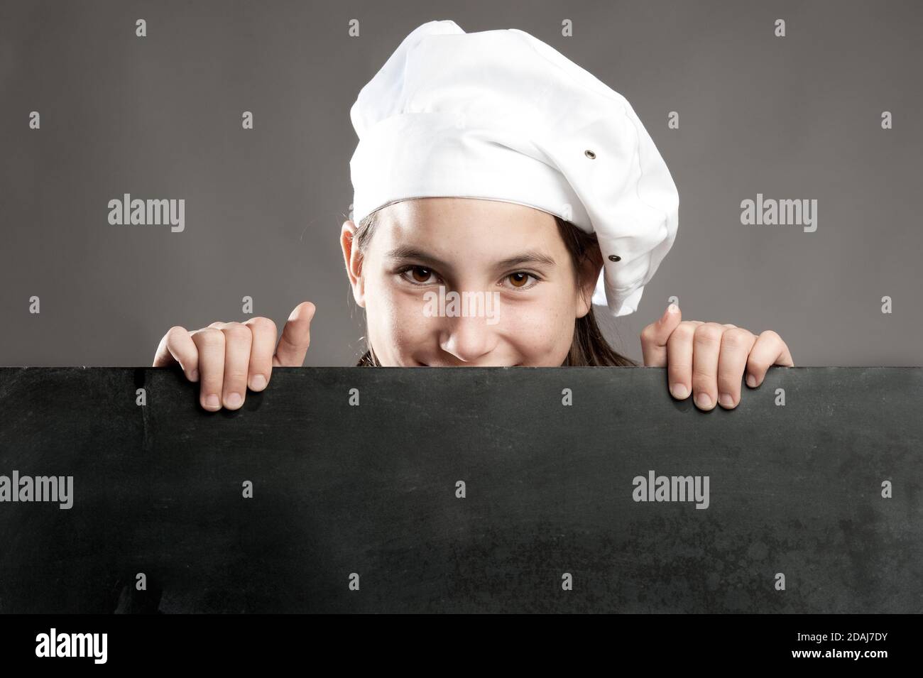 young chef holding menu chalkboard Stock Photo - Alamy