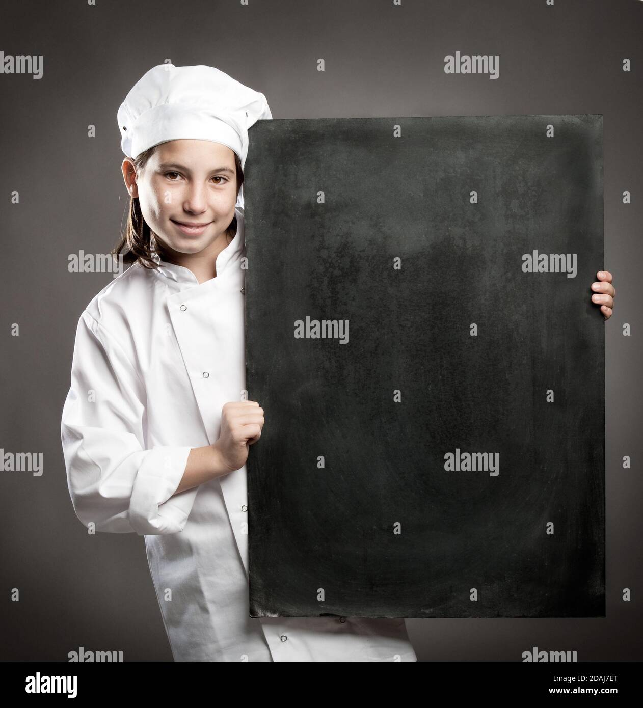 young chef holding menu chalkboard Stock Photo - Alamy