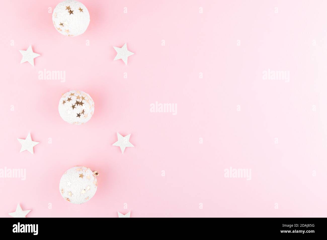 Christmas white balls, sequins on stylish pink table top view. Fashion ...