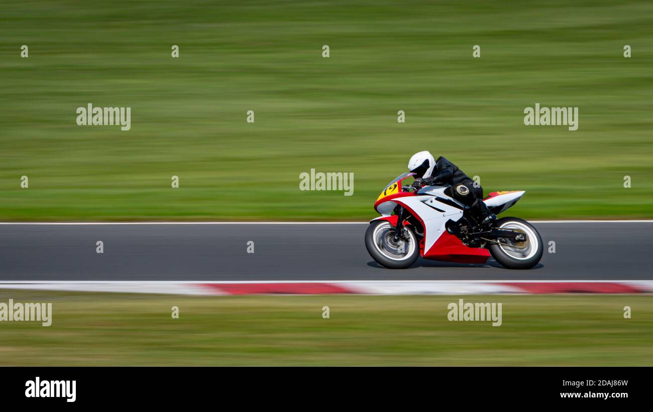 A panning shot of a racing bike cornering on a track Stock Photo - Alamy