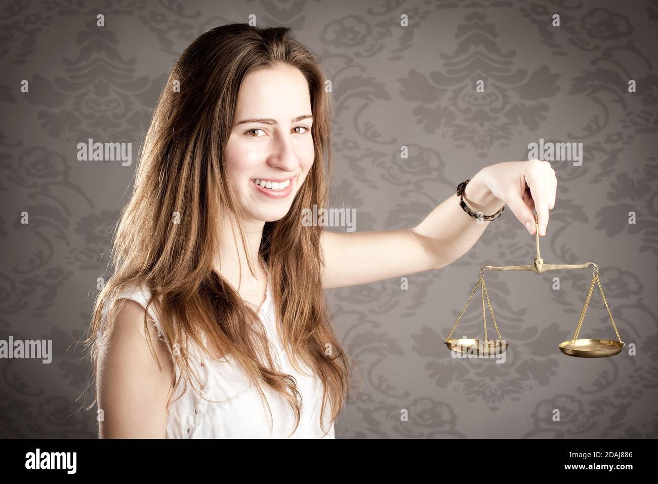 young woman holding a justice scale looking at camera Stock Photo - Alamy