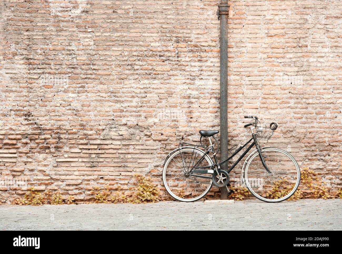 old black bicycle against a bricks wall Stock Photo - Alamy