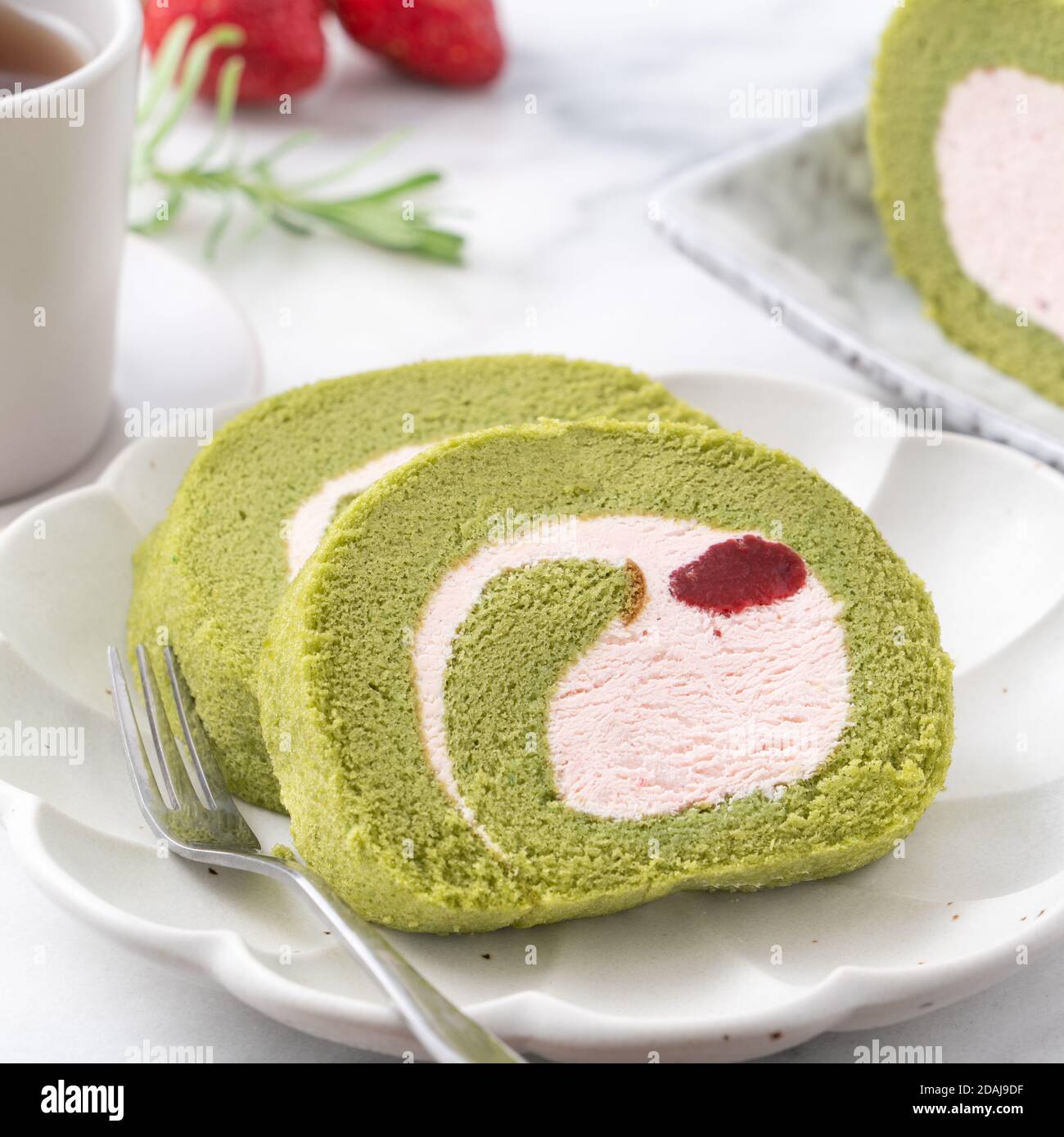 Delicious Matcha Swiss Roll Cake slices with strawberry icing cream on ...