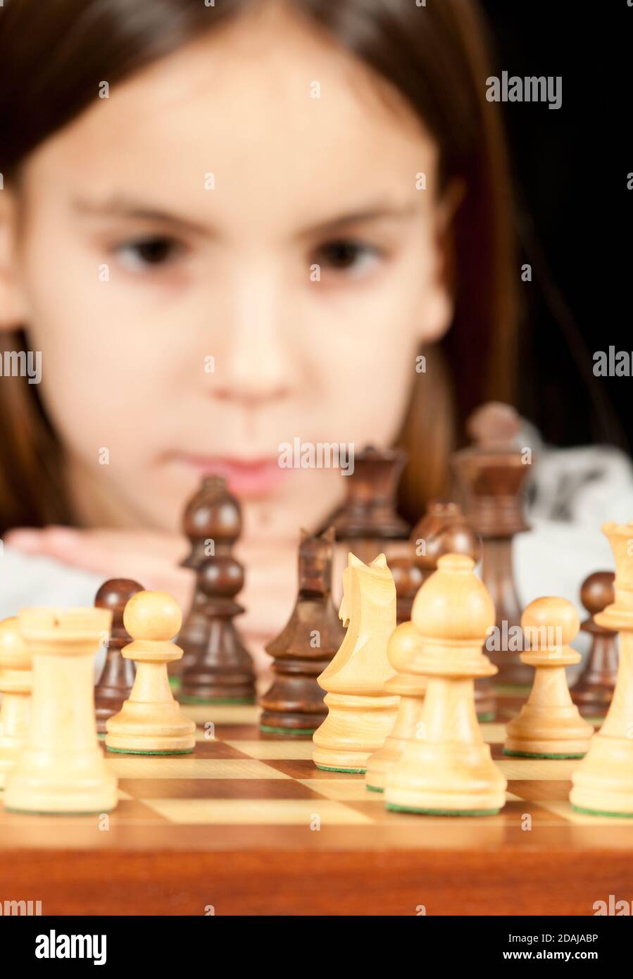little girl playing chess on a vintage background Stock Photo - Alamy