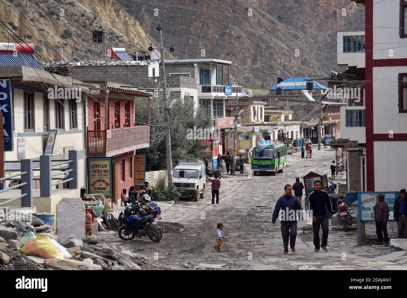 The main street of the city of Jomsom with offices, shops, transport ...
