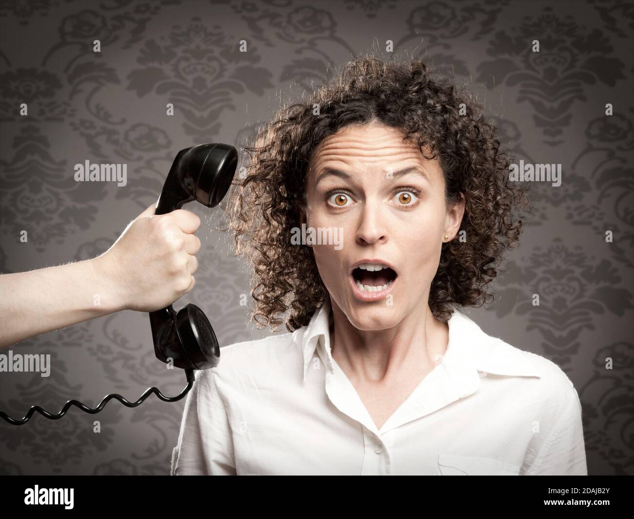 woman attending a phone call with surprise Stock Photo - Alamy