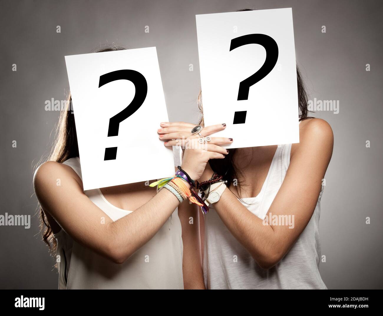 young women with interrogation symbols in front of their faces Stock ...