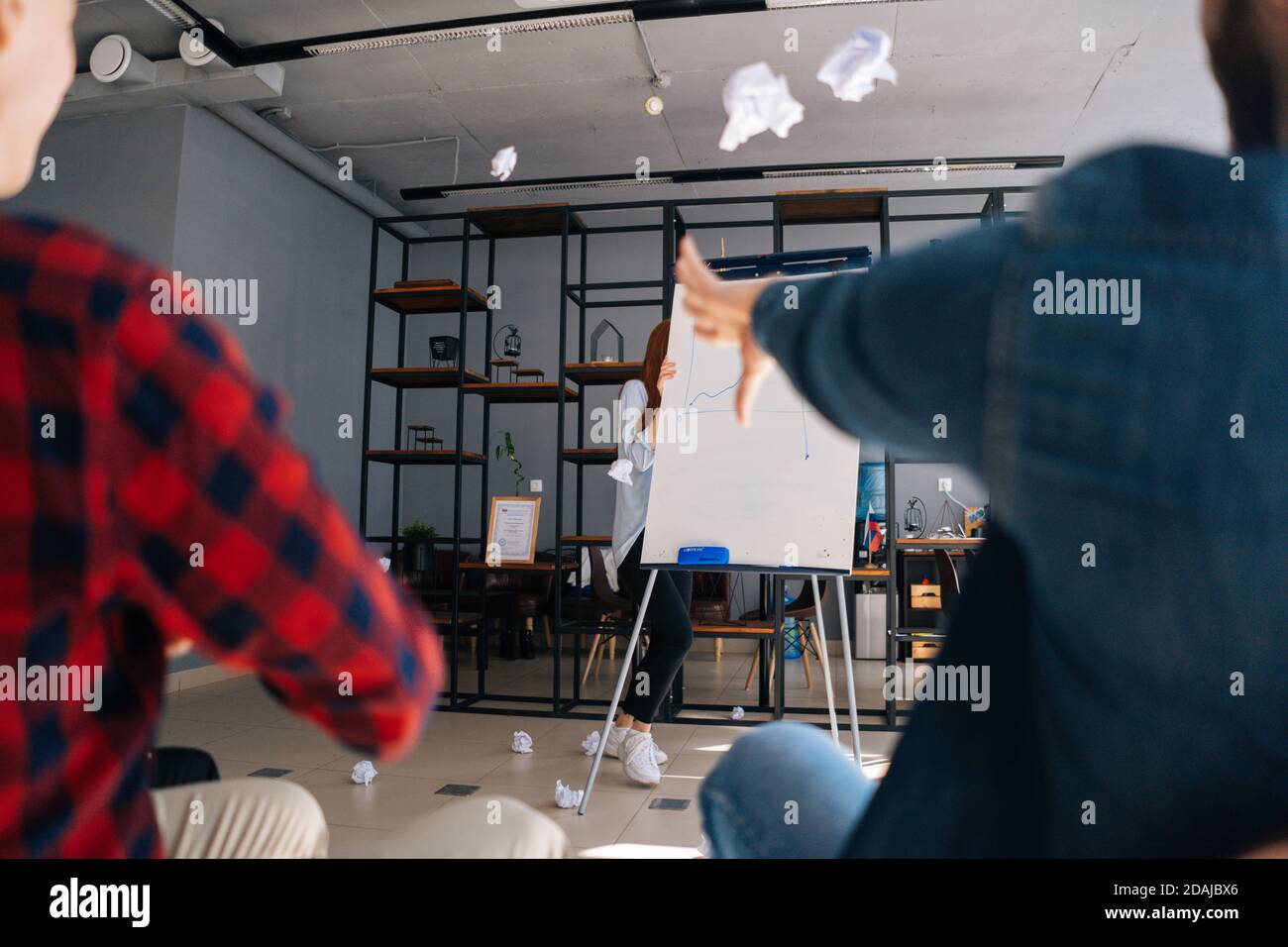Back view of cheerful young business lady finishing presentation on ...