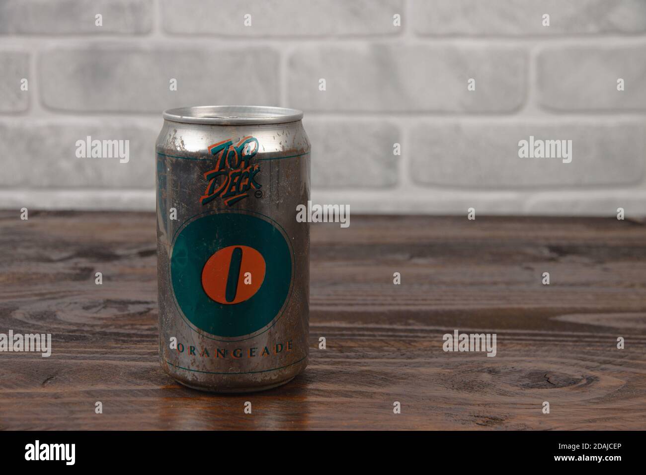 An old aluminium can of Top Deck soft drink against the brick wall ...