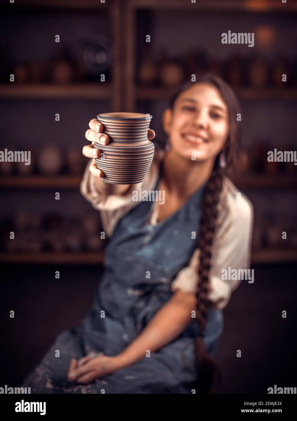 Artisan shows the finished clay product in workshop. Hand work Stock ...