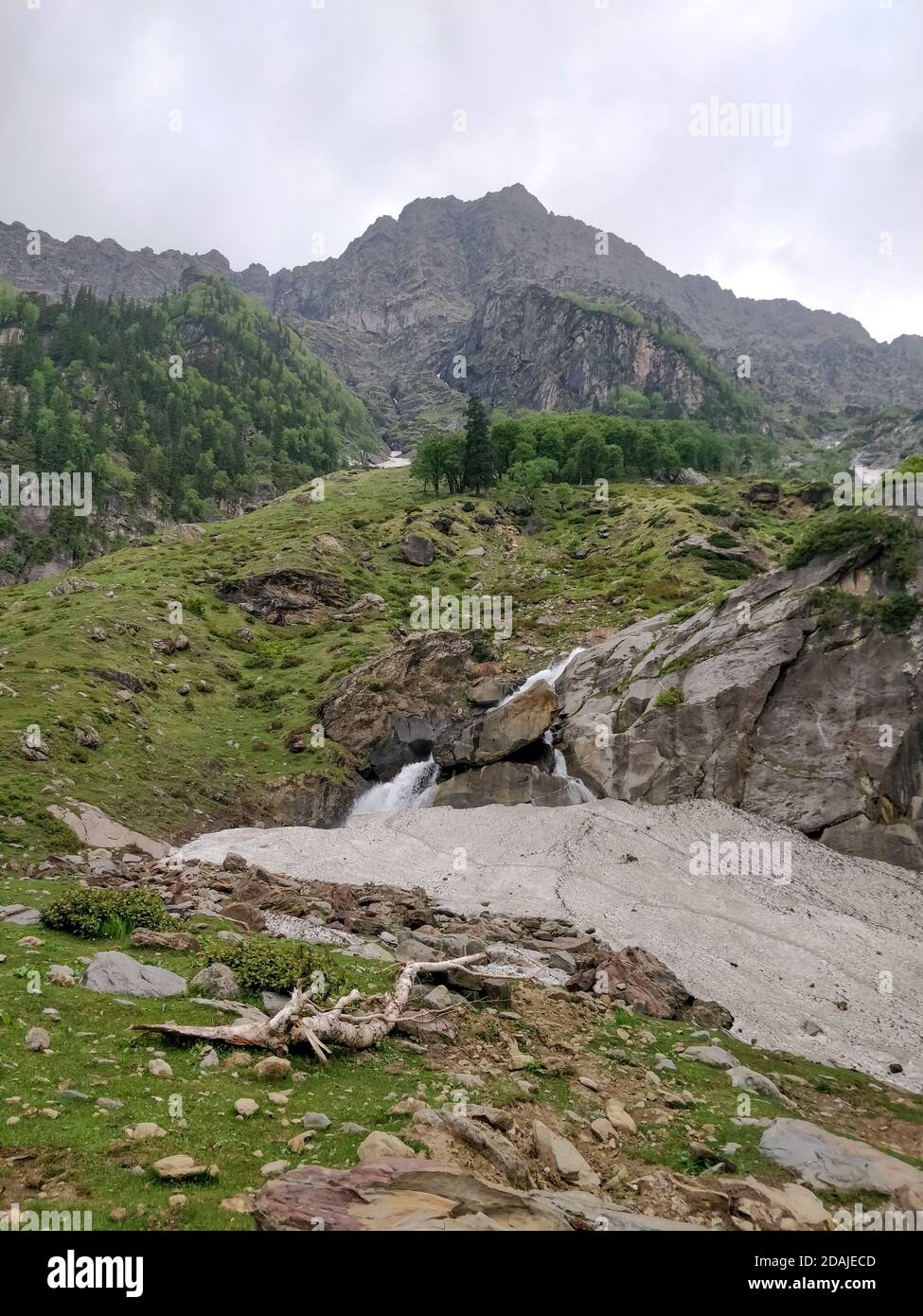 Beautiful water fall flowing under a snow glacial patch in an epic ...