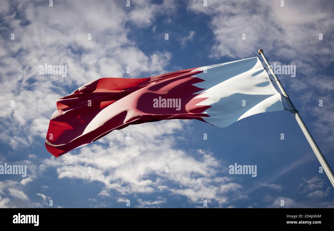Beautiful national state flag of Qatar fluttering at sky background ...