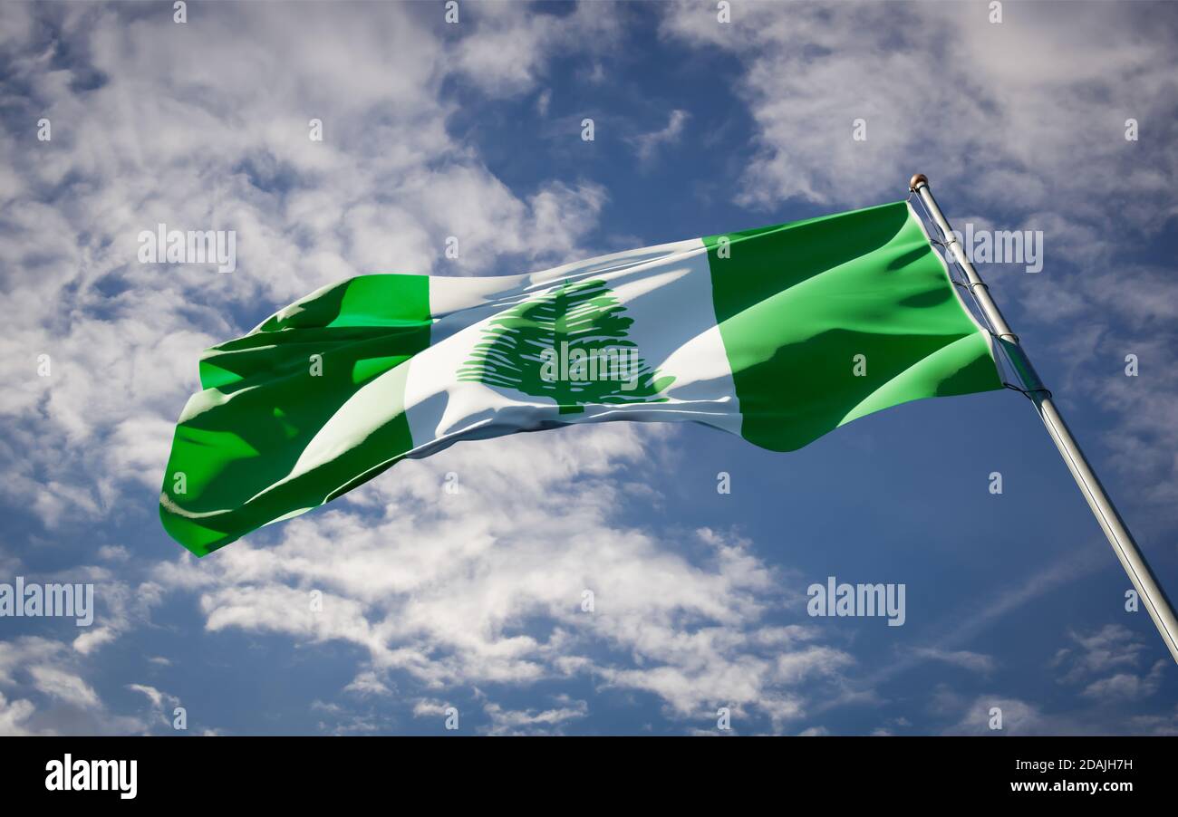 Beautiful national state flag of Norfolk fluttering at sky background ...