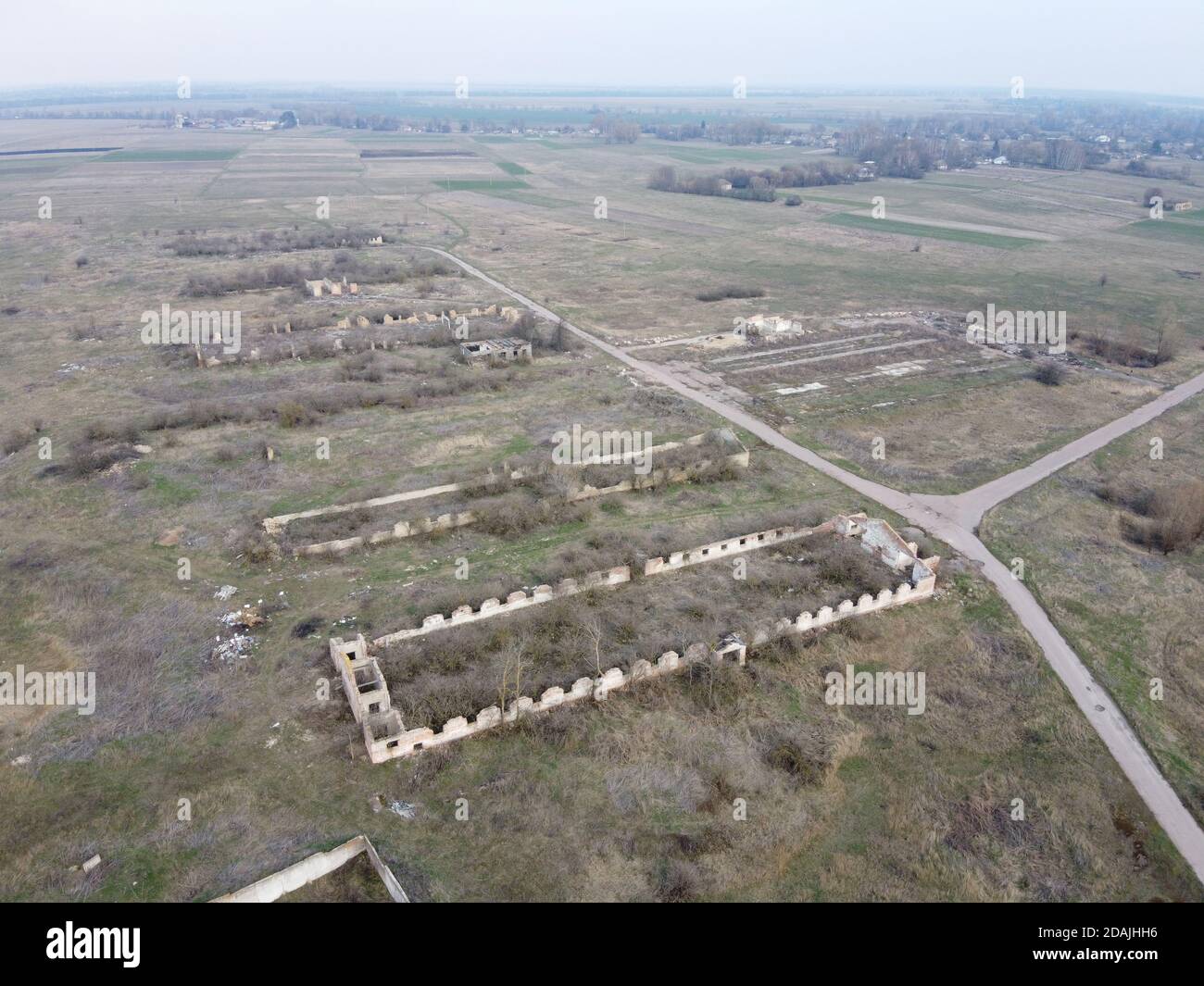 Destroyed agricultural buildings, aerial view. Abandoned livestock farm ...