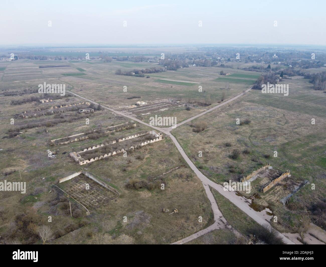 Destroyed agricultural buildings, aerial view. Abandoned livestock farm ...