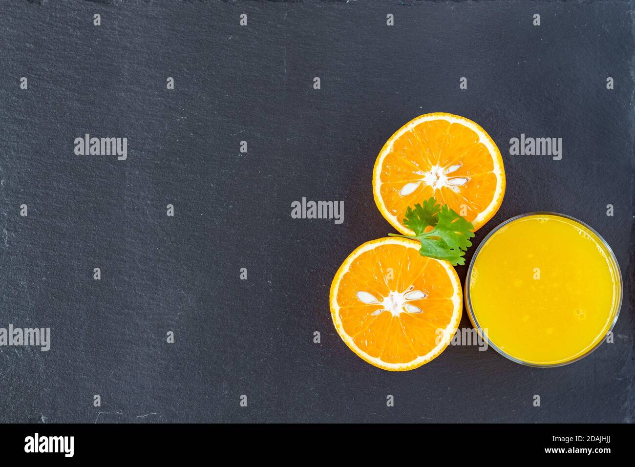 Glass of orange and orange juice cut in half Stock Photo - Alamy
