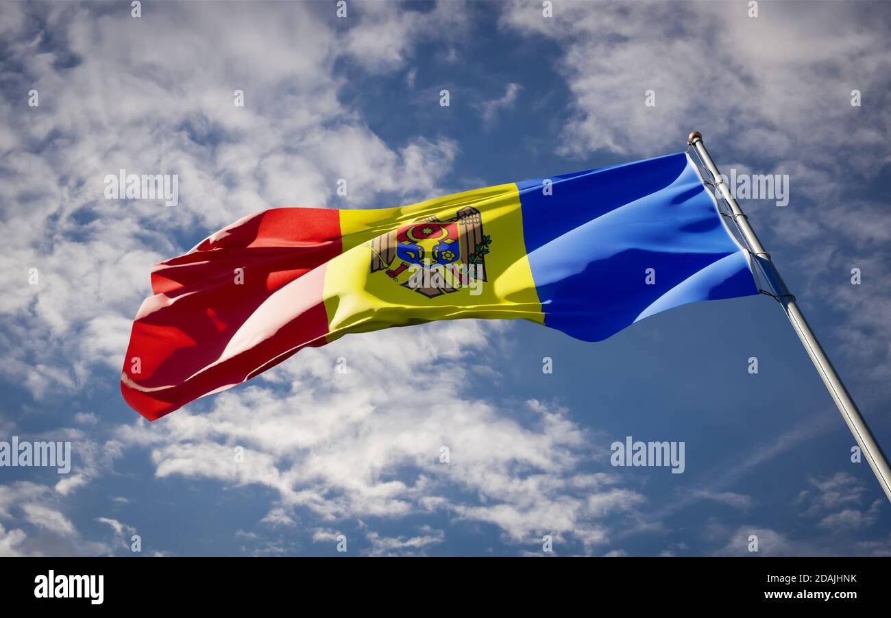 Beautiful national state flag of Moldova fluttering at sky background ...
