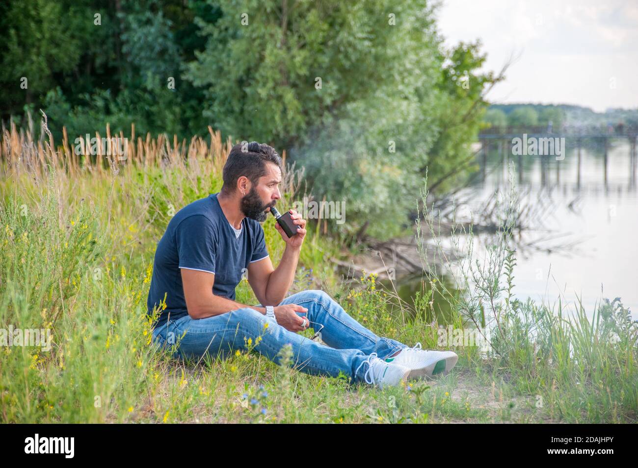 Stylish smoker smoking an vape outdoorr. Handsome man Stock Photo - Alamy
