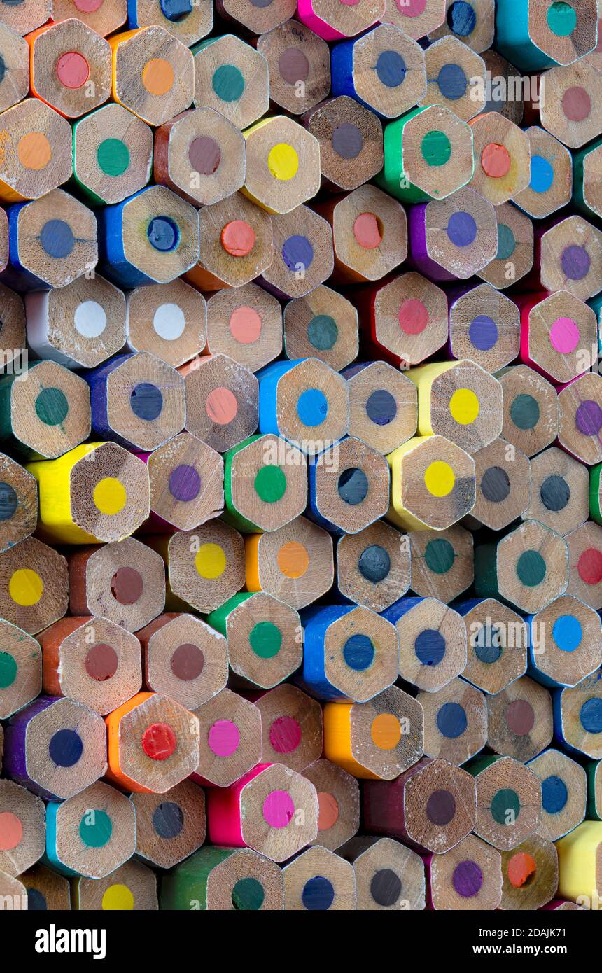 Collection of coloured pencils in a diagonal line pattern as background ...